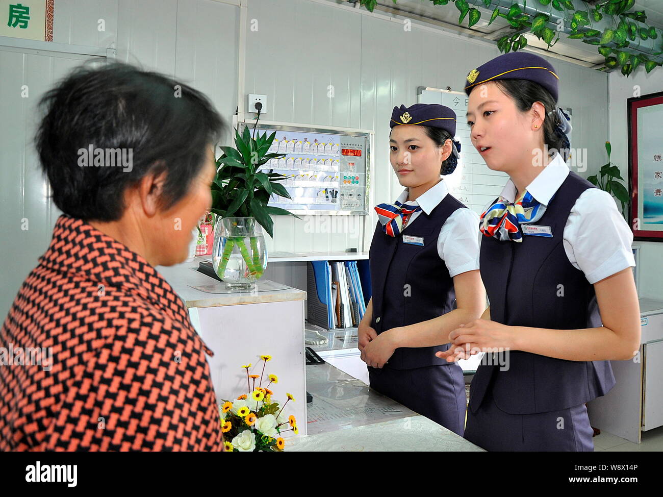 Chinese nurses dressed like flight attendants serve a patient at the ...