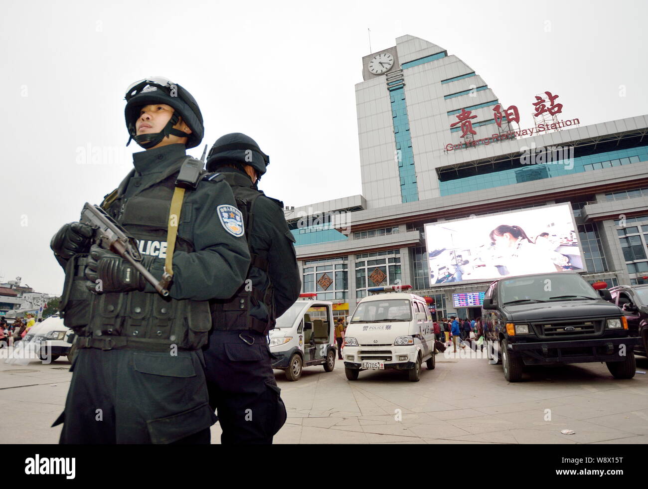 Armed Chinese police officers stand guard at the Guiyang Railway ...