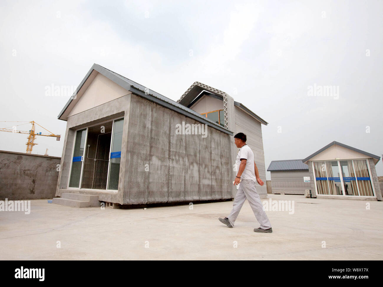 A man walks past 3D printed houses at the Qingpu Park of the Shanghai ...
