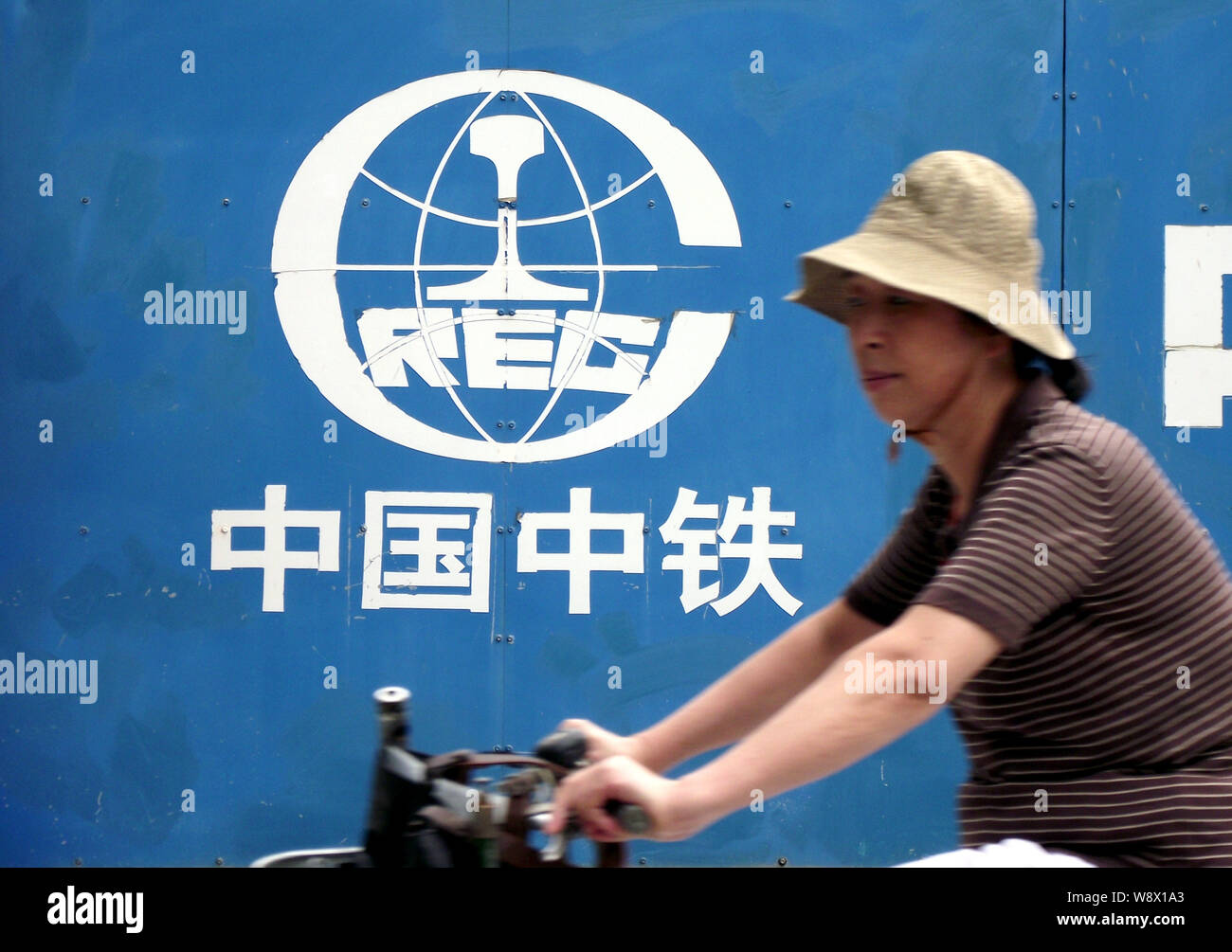 --FILE--A cyclist rides past an advertisement for CREC (China Railway ...