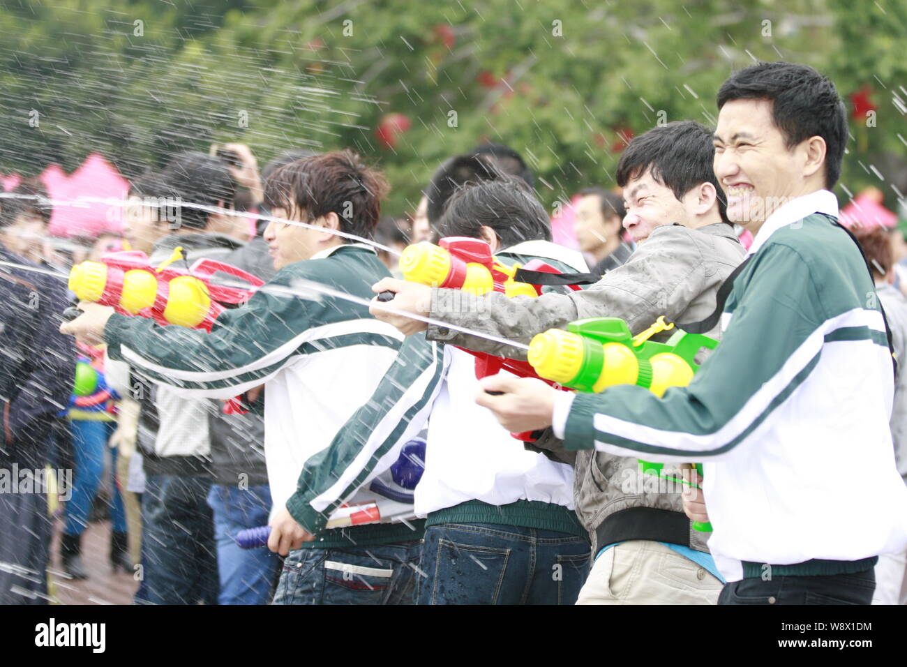 Local residents shoot one another with water guns during the Water ...