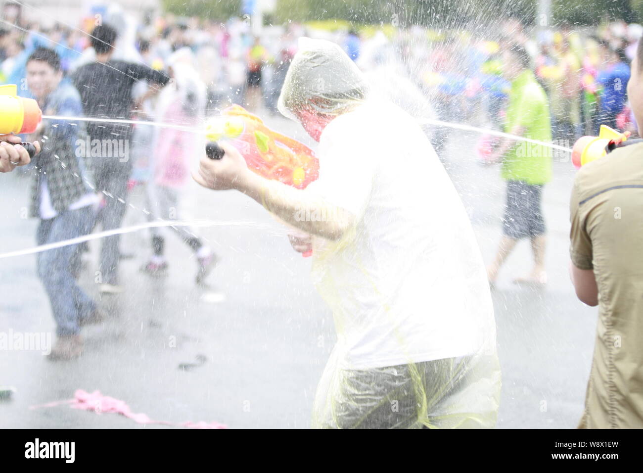 Local residents shoot one another with water guns during the Water ...