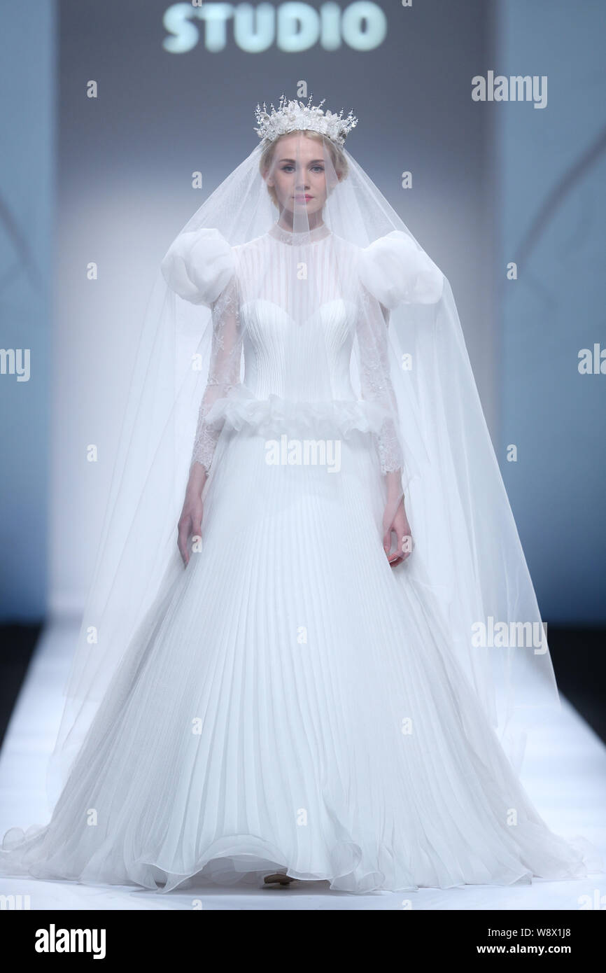 A model displays a new creation at the fashion show of Disney Princess ...