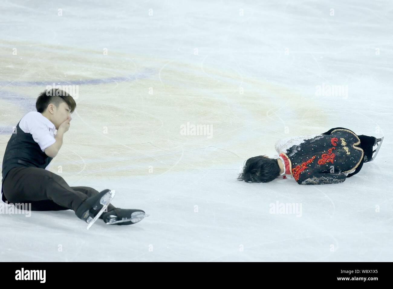 Hanyu Yuzuru of Japan, right, and Yan Han of China fall on the ice ...