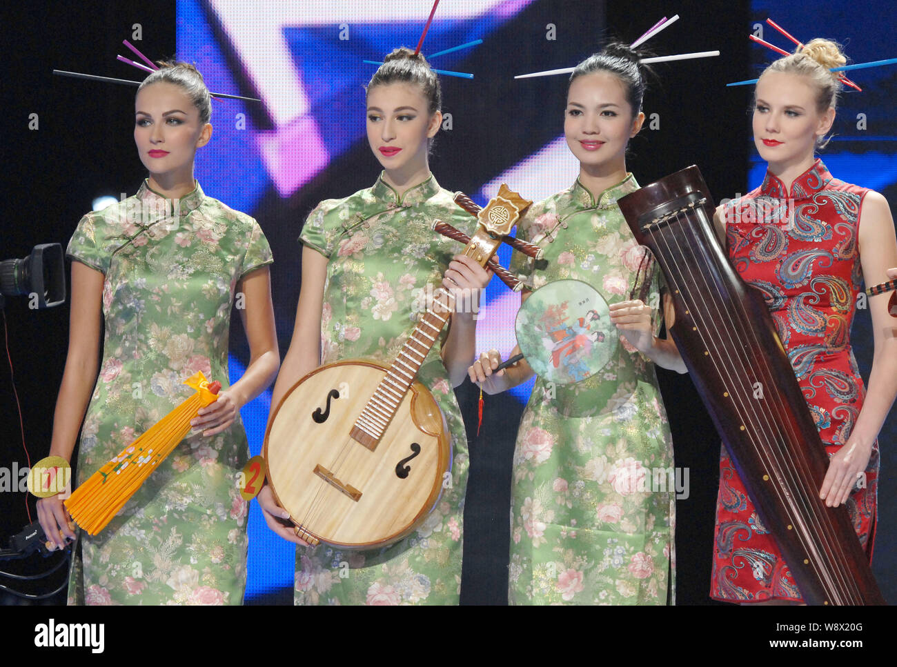Chinese and foreign models display creations of cheongsam, also known ...