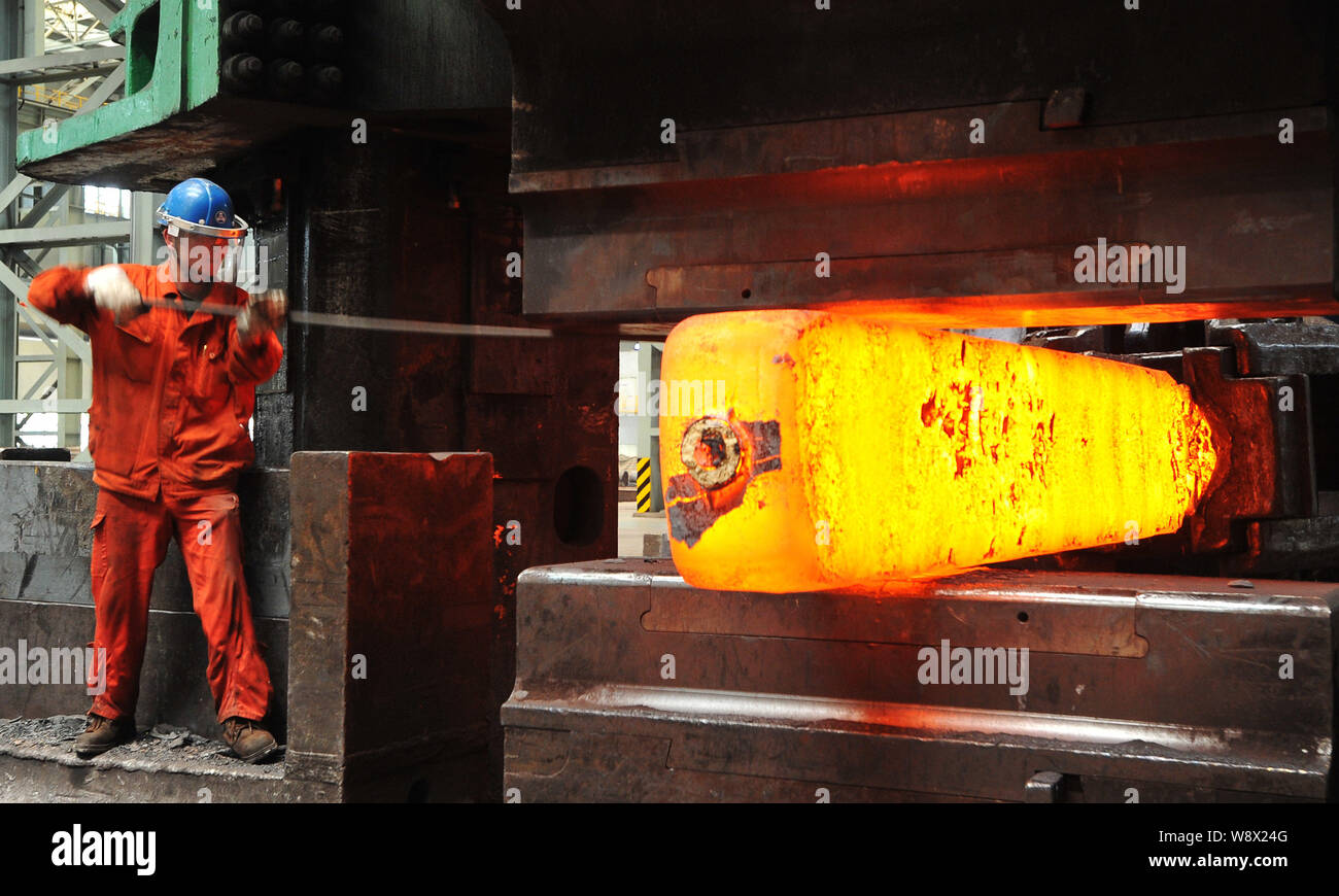 --FILE--A Chinese worker produces a steel bar at a plant of Dongbei ...