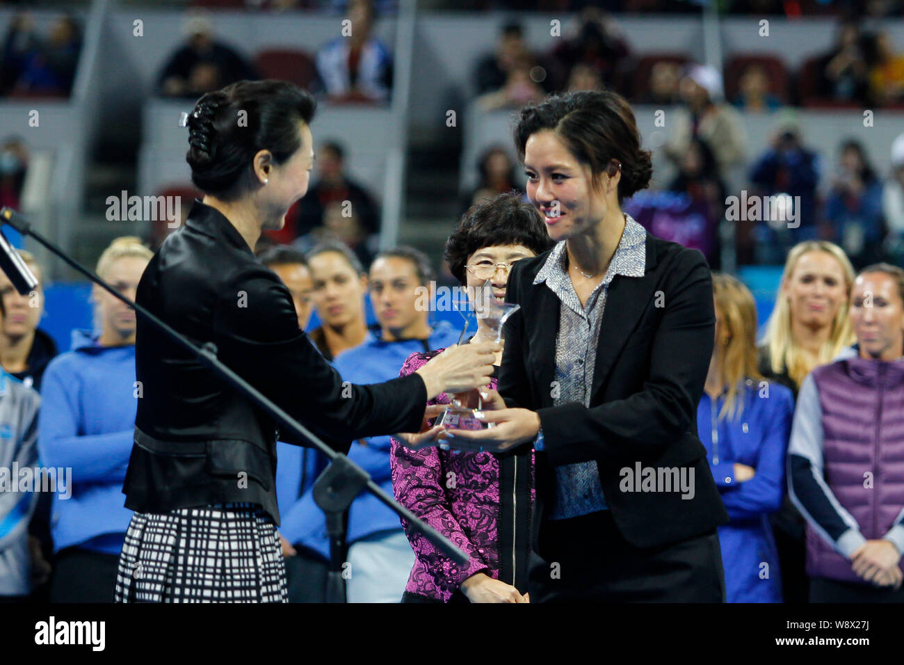 Chinese tennis player Li Na, right, receives an award during her ...