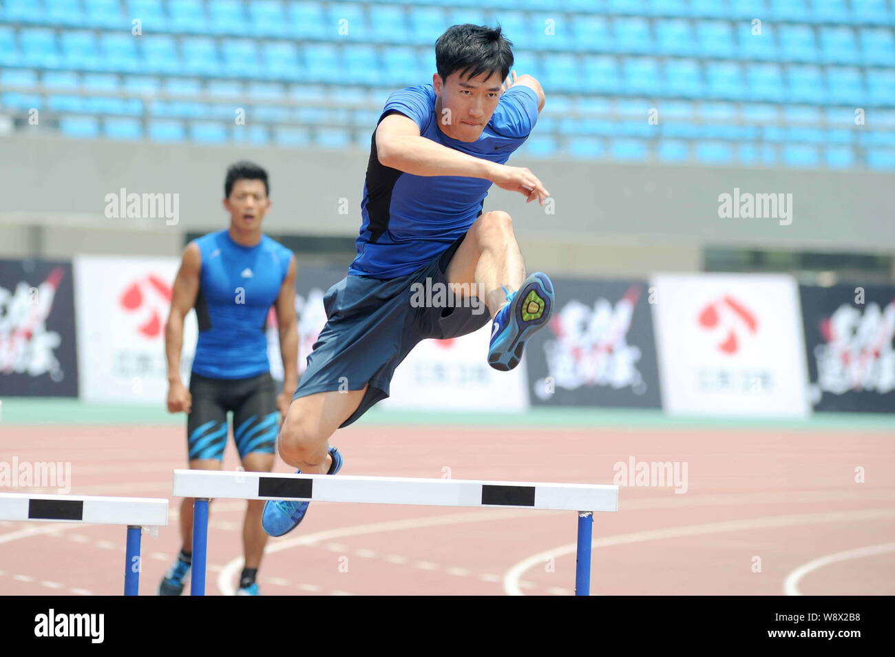 --FILE--Chinese star hurdler Liu Xiang, front, shows his hurdle skills ...