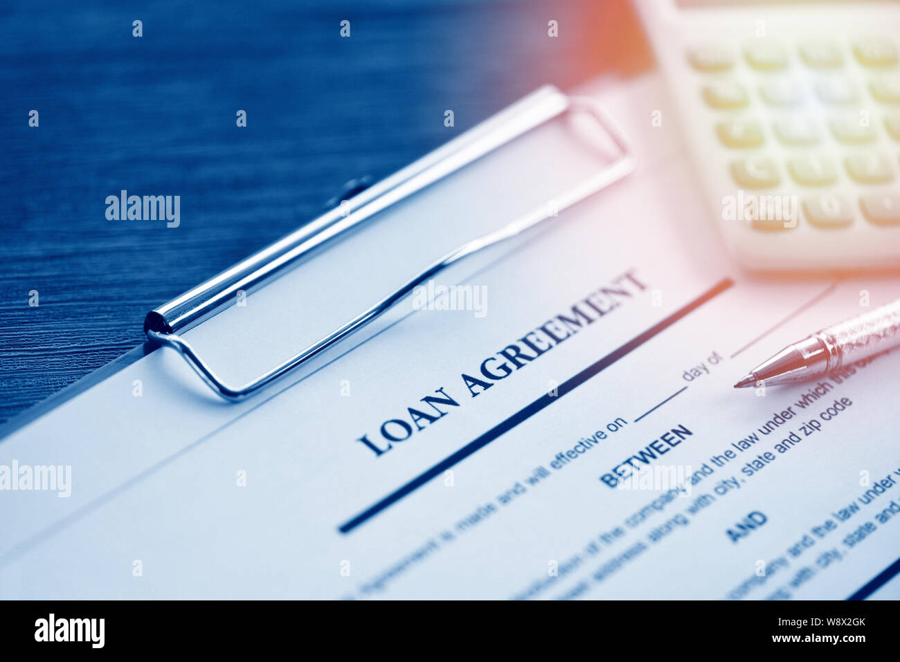 loan agreement application form with pen and calculator on paper ...