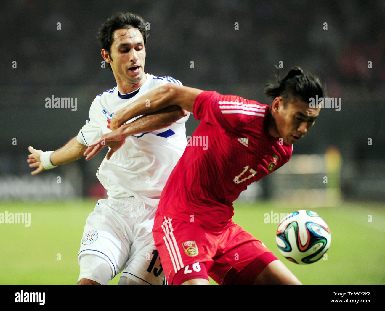 Zhang Chengdong of China, front, challenges David Mendoza of Paraguay ...