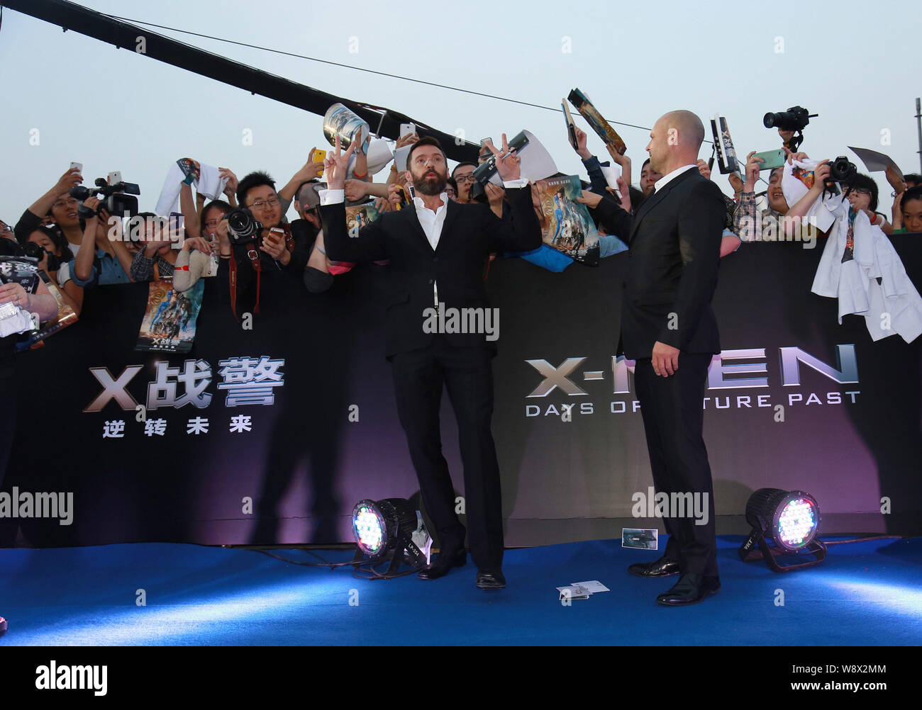 Australian actor Hugh Jackman, front left, shows peace signs in front ...