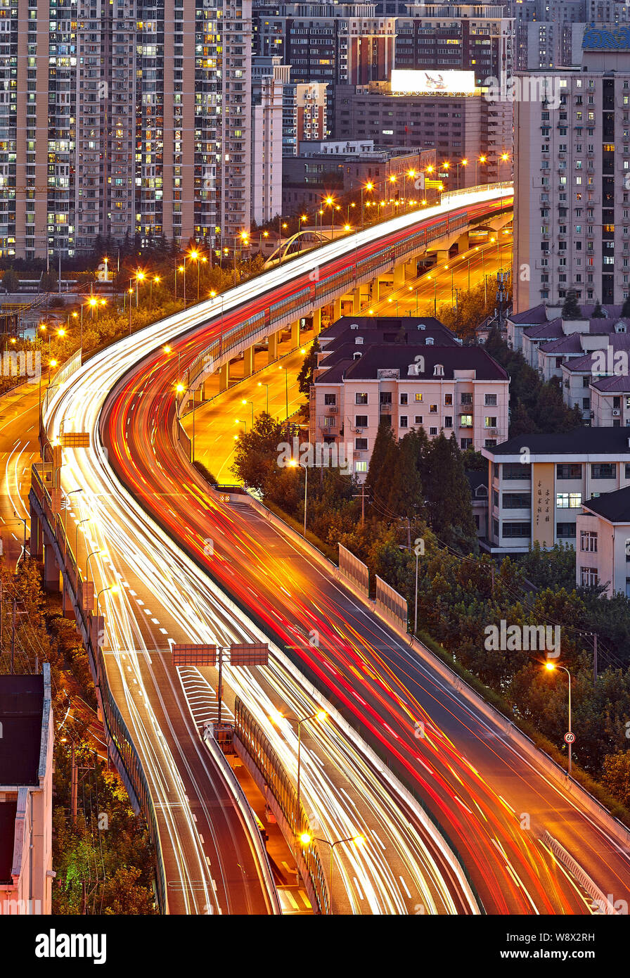 Night view of elevated highways next to high-rise buildings in downtown ...