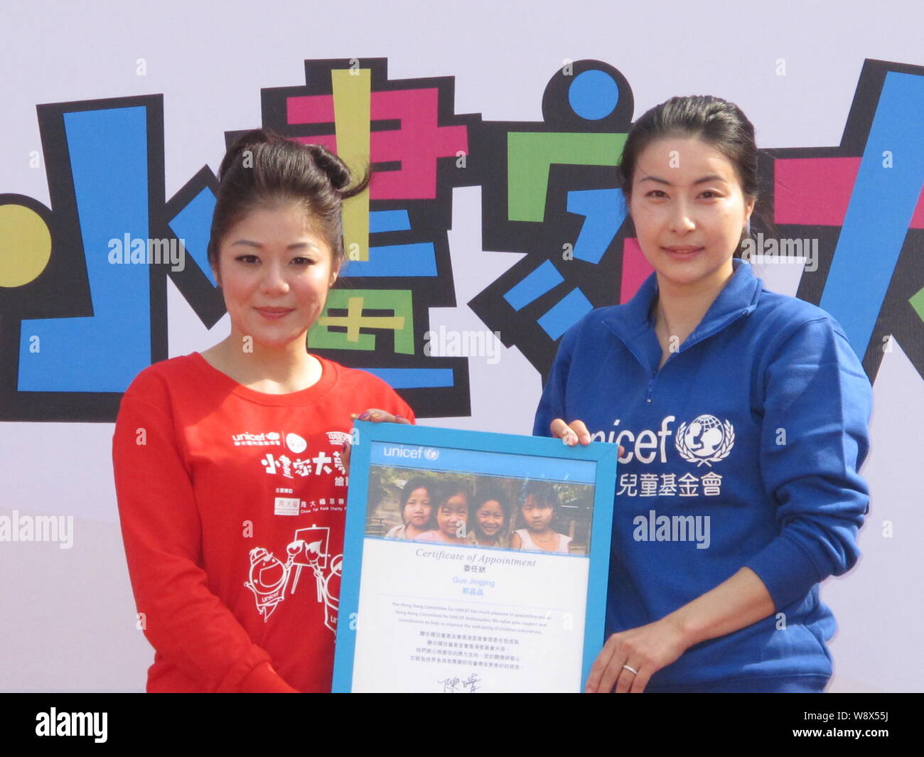 Chinese Olympic diving champion Guo Jingjing, right, receives the ...