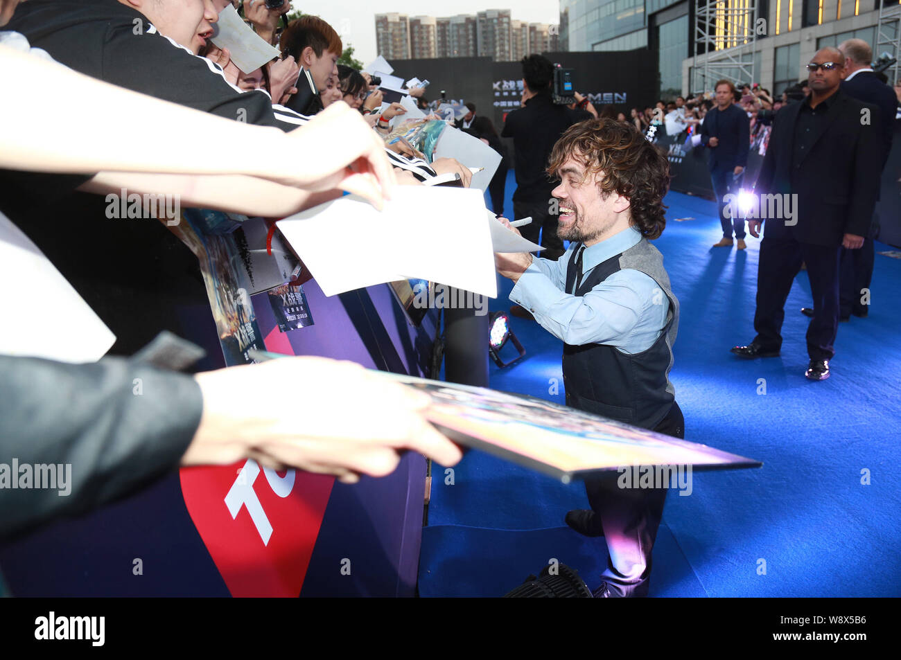 American actor Peter Dinklage signs autographs for fans as he arrives ...