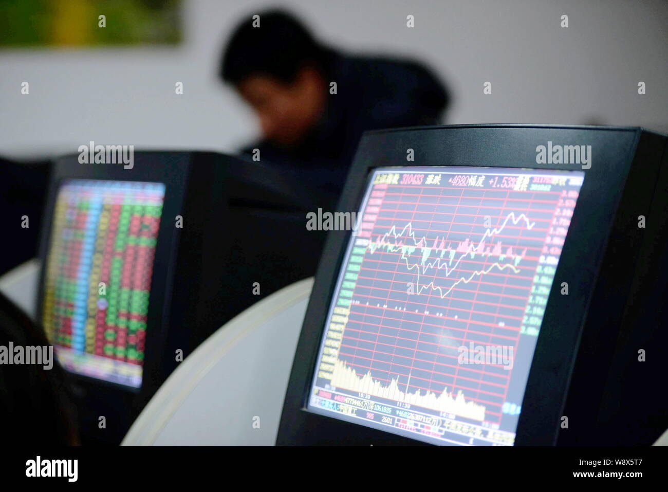 Computer displays show prices of shares (red for price rising and green ...