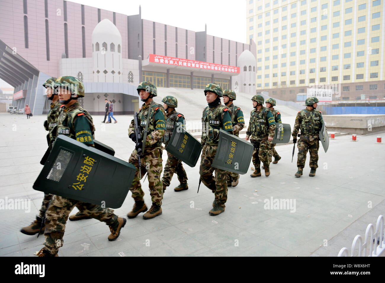 --FILE--Armed Chinese paramilitary policemen patrol a street in Kashgar ...