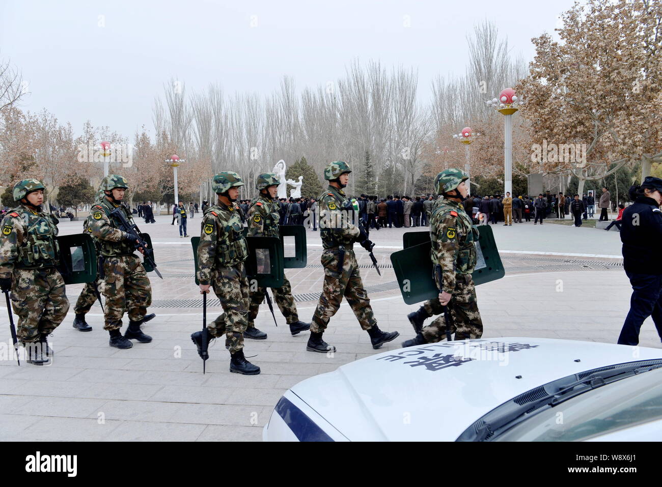 --FILE--Armed Chinese paramilitary policemen patrol a park in Kashgar ...