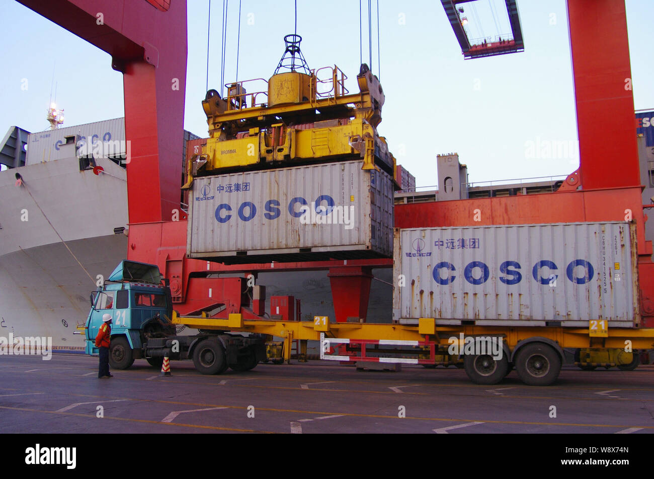 --FILE--A crane vehicle unloads a container of COSCO from a truck at ...