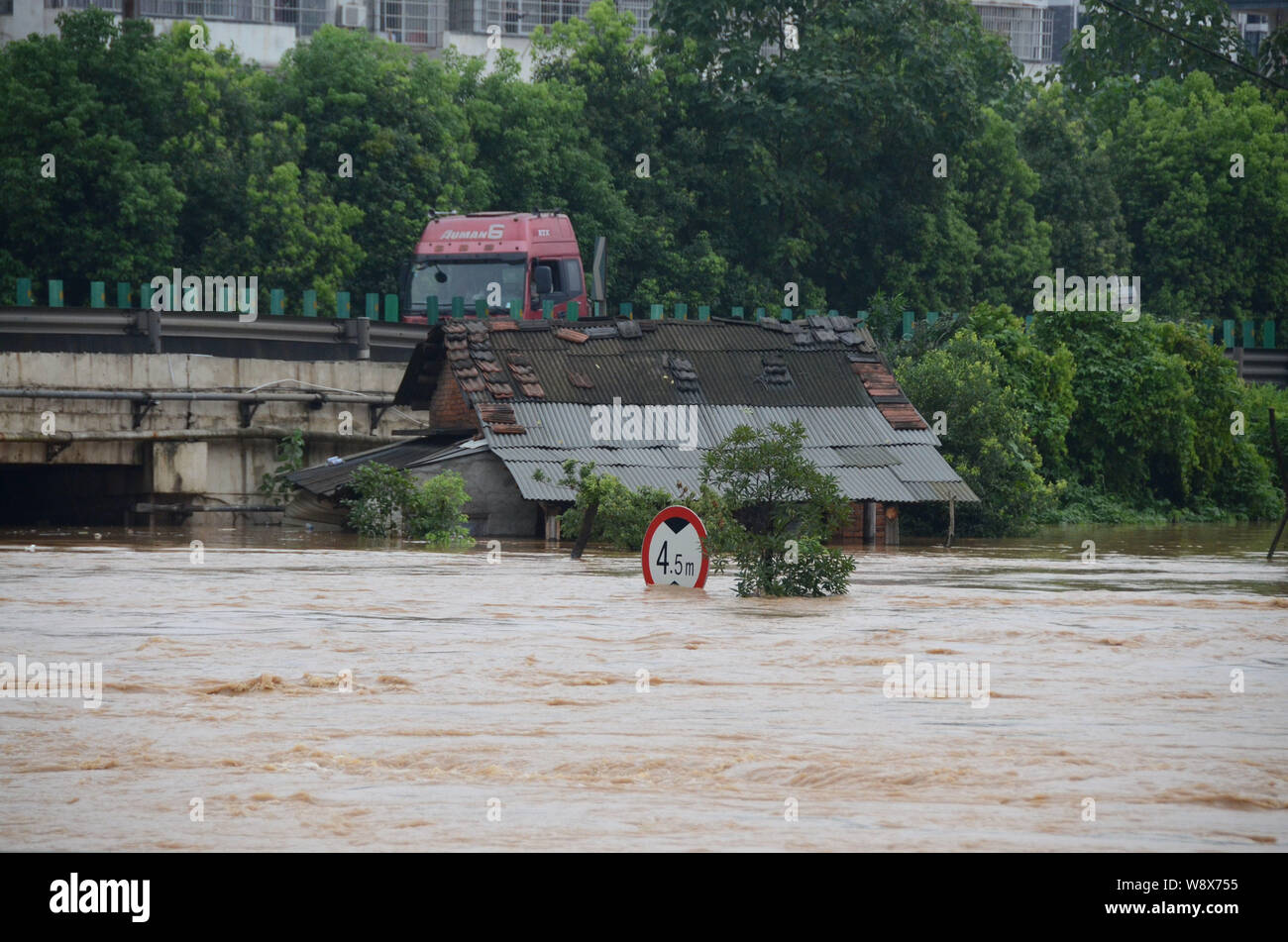 Houses are submerged by floods caused by heavy rains from Typhoon Matmo ...