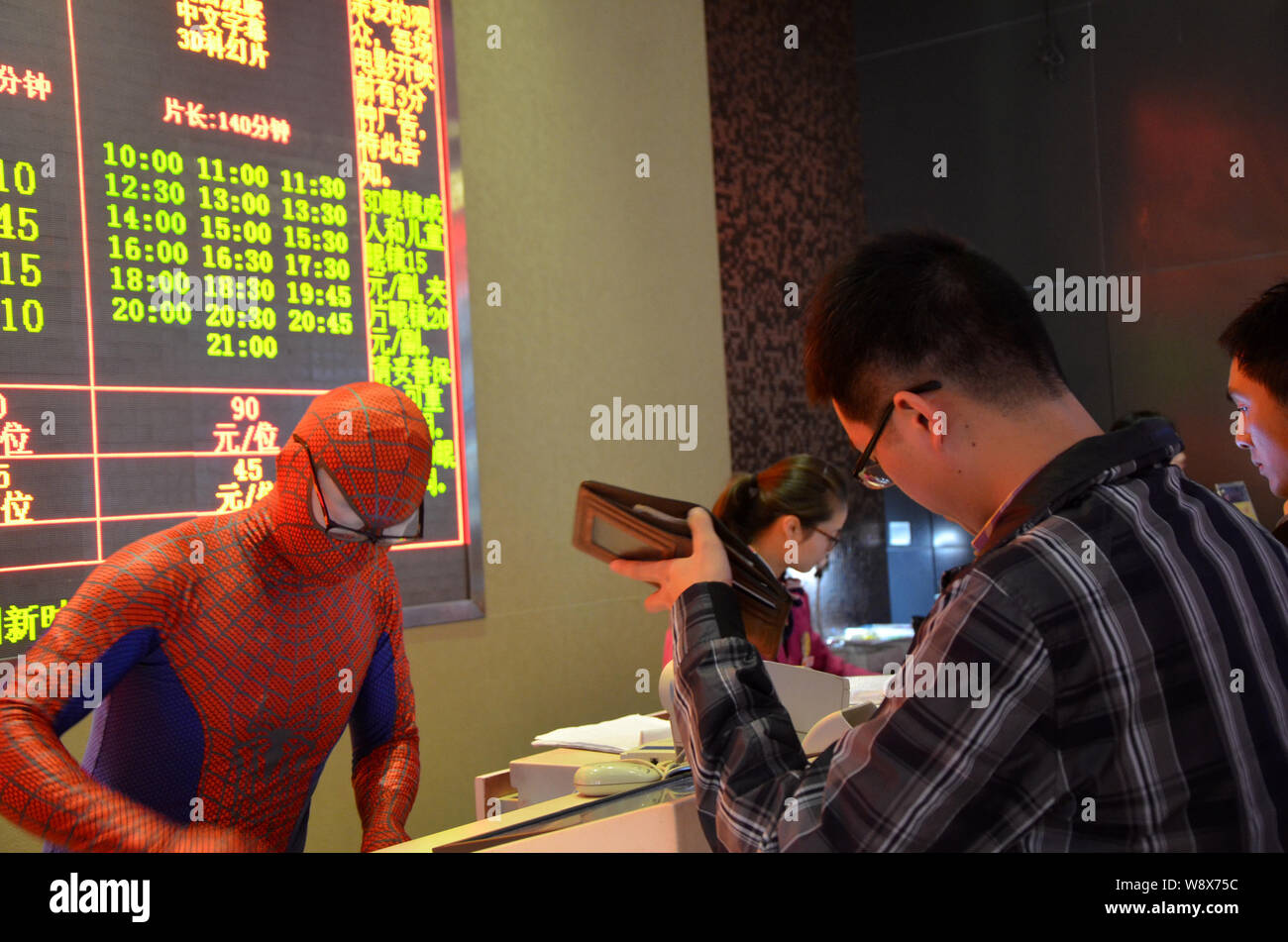 An entertainer dressed in the Spider-man costume sells tickets of the ...