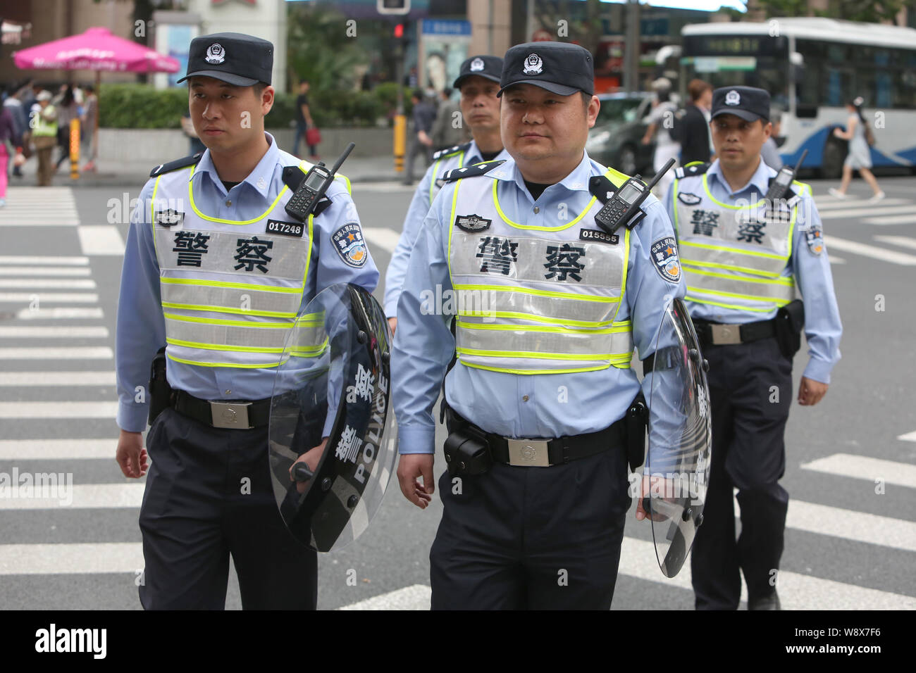 Chinese police officers armed with shields patrol on Huaihai Road in ...