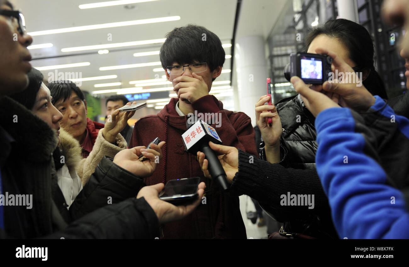 A scared passenger, center, who was aboard the malfunctioning China ...