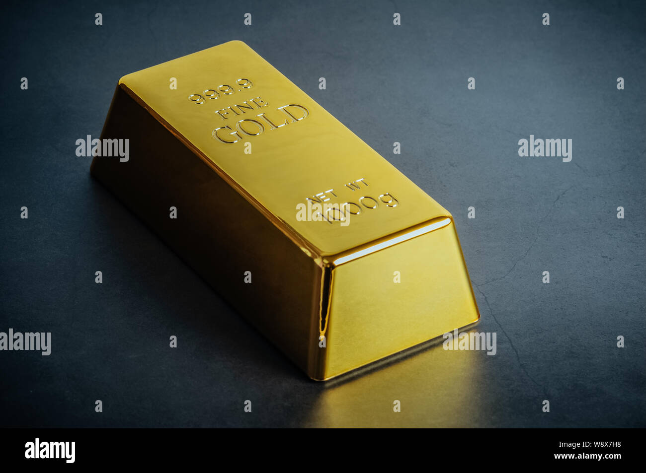 Gold bar ingot bullion on blue background. Located diagonally Stock ...