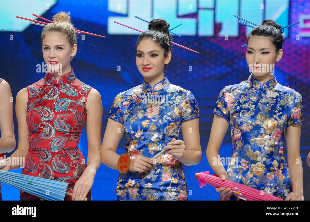 Chinese and foreign models display creations of cheongsam, also known ...