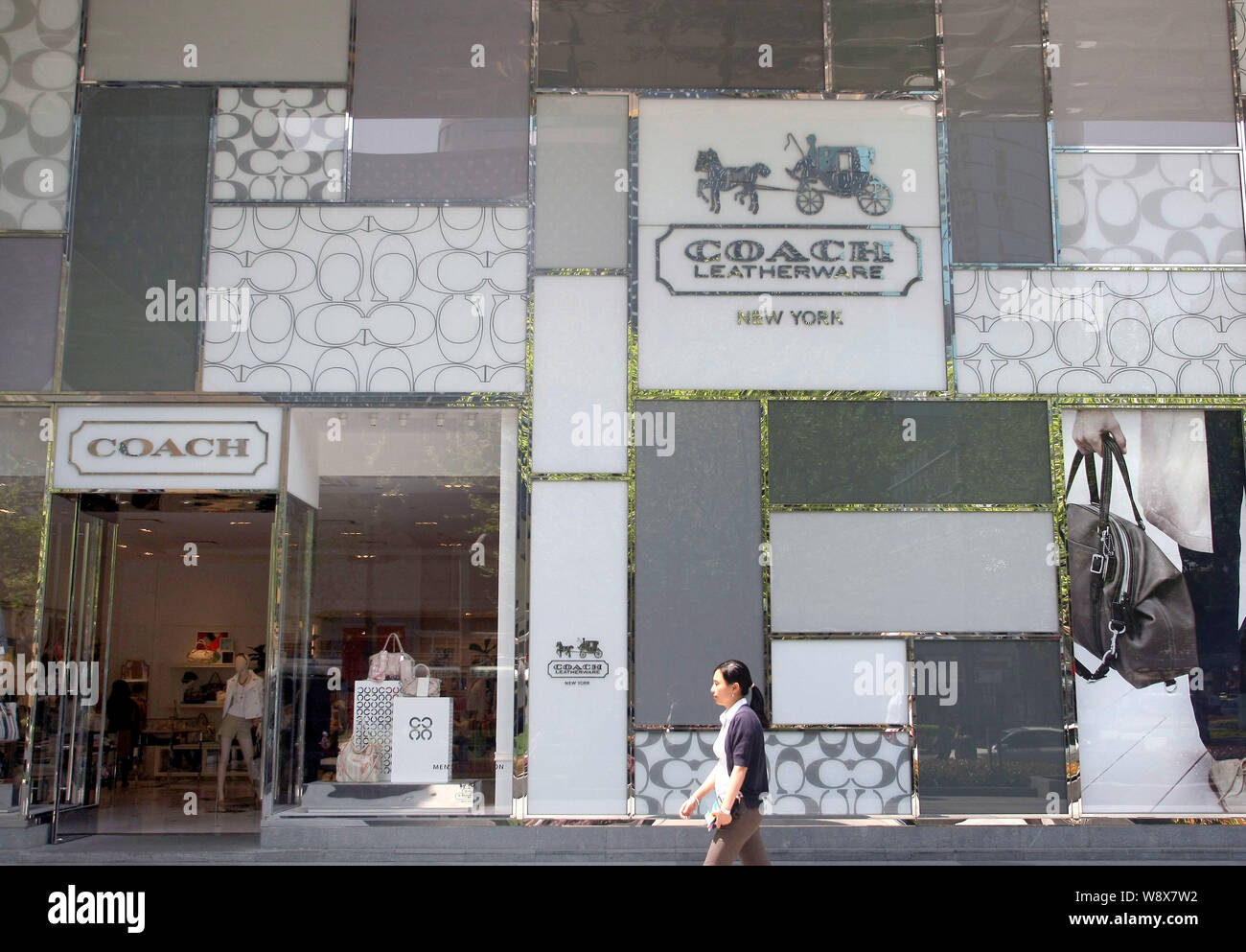 --FILE--A pedestrian walks past a boutique of Coach in Shanghai, China ...