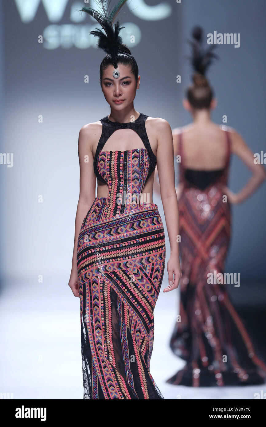 A model displays a new creation at the fashion show of Disney Princess ...