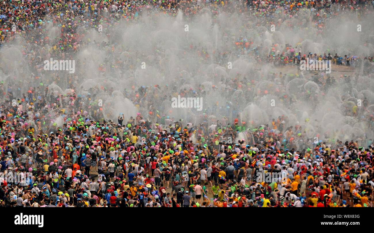 Crowds of local people splash water to celebrate the New Year of Dai ...