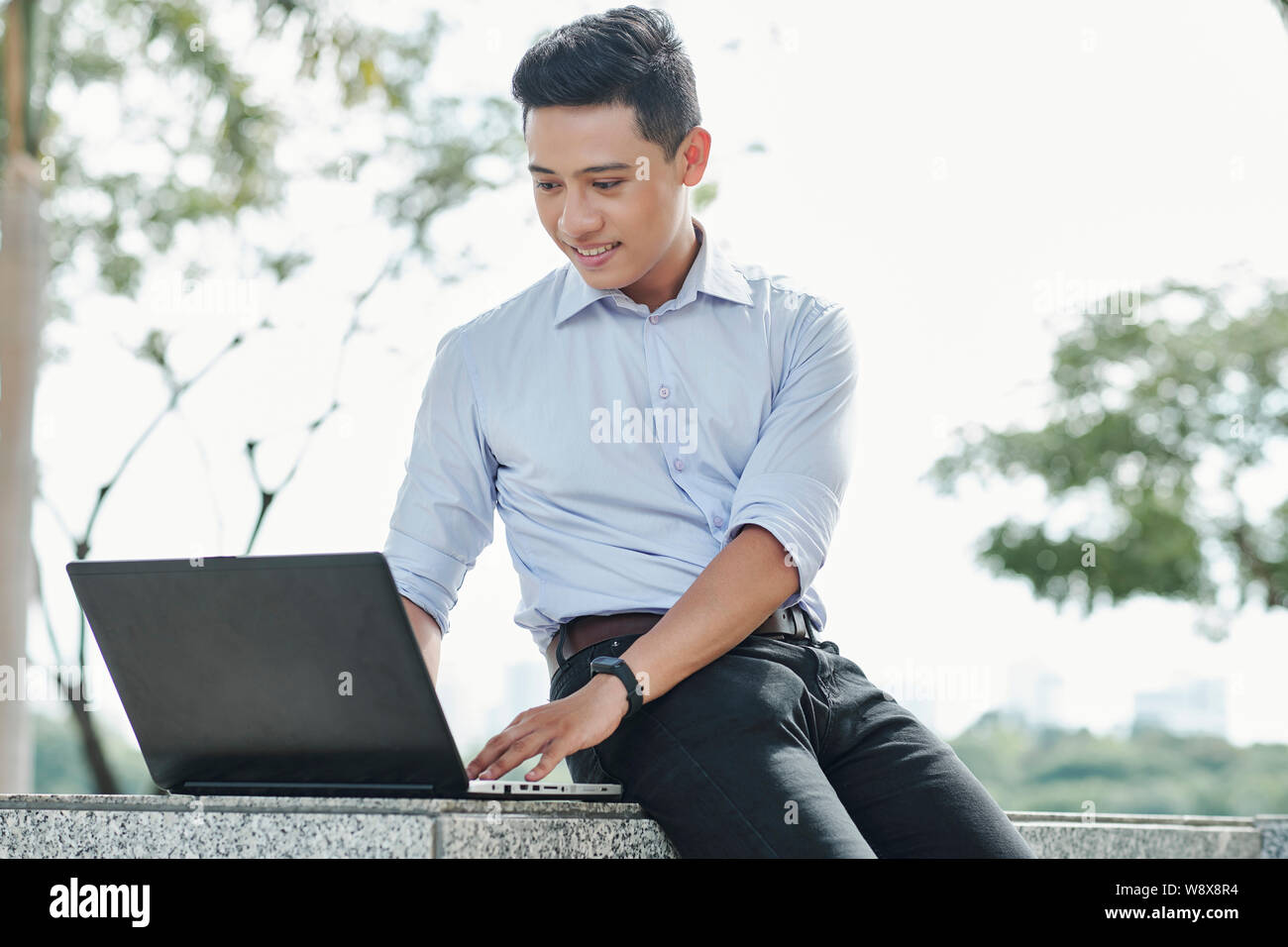 Software developer working on laptop outdoors Stock Photo - Alamy