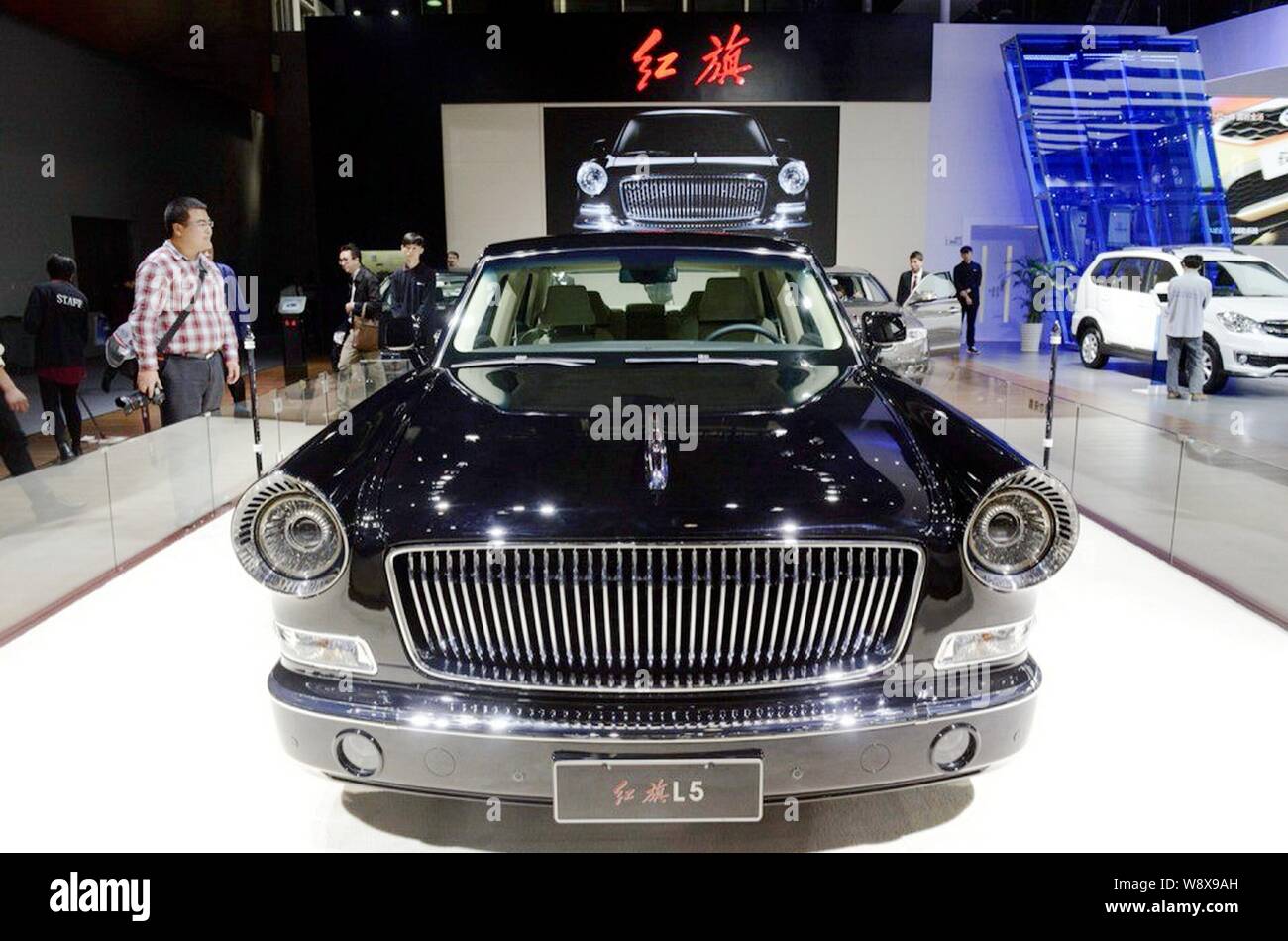 Visitors look at a Hongqi (Red Flag) L5 limousine of FAW on display ...