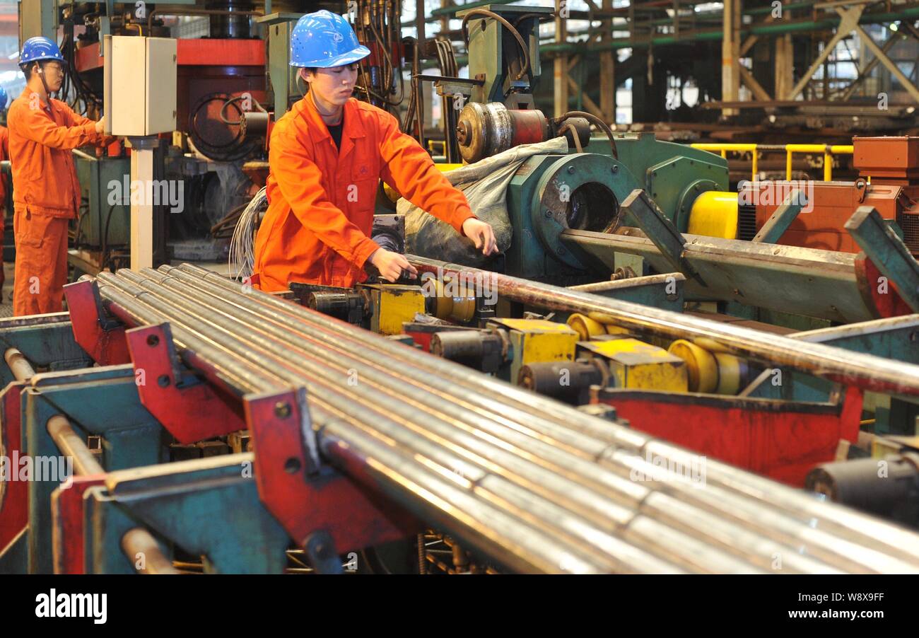 --FILE--A female Chinese worker processes steel bars to be shipped ...