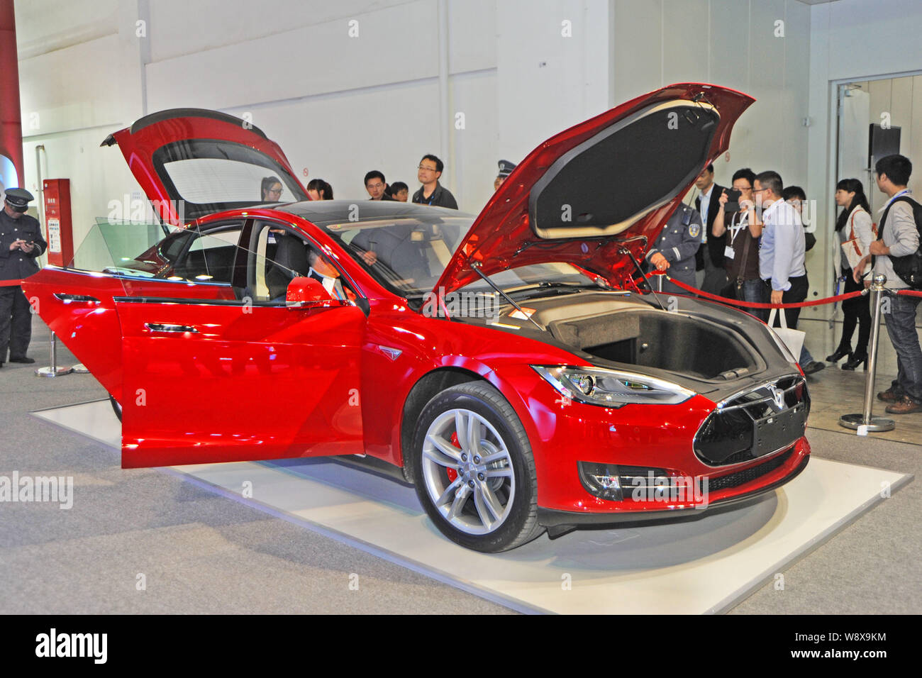 --FILE--Visitors look at a Tesla Model S electric car on display during ...