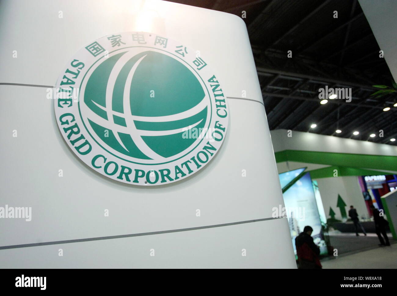 --FILE--Visitors walk past the stand of State Grid Corporation of China ...