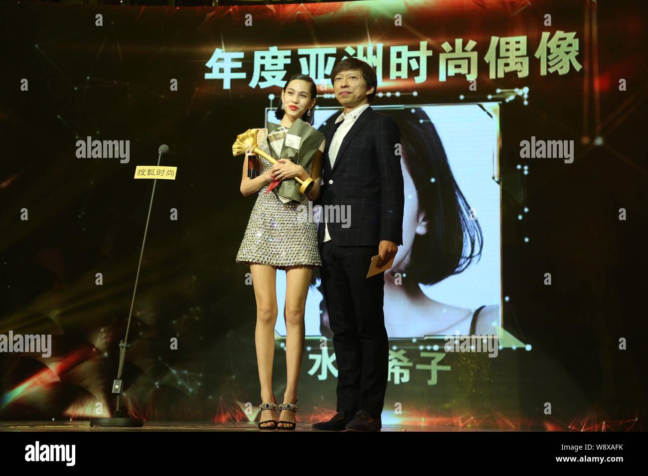 Japanese actress Kiko Mizuhara, left, poses with Charles Zhang Chaoyang, CEO of Sohu.com Inc ...