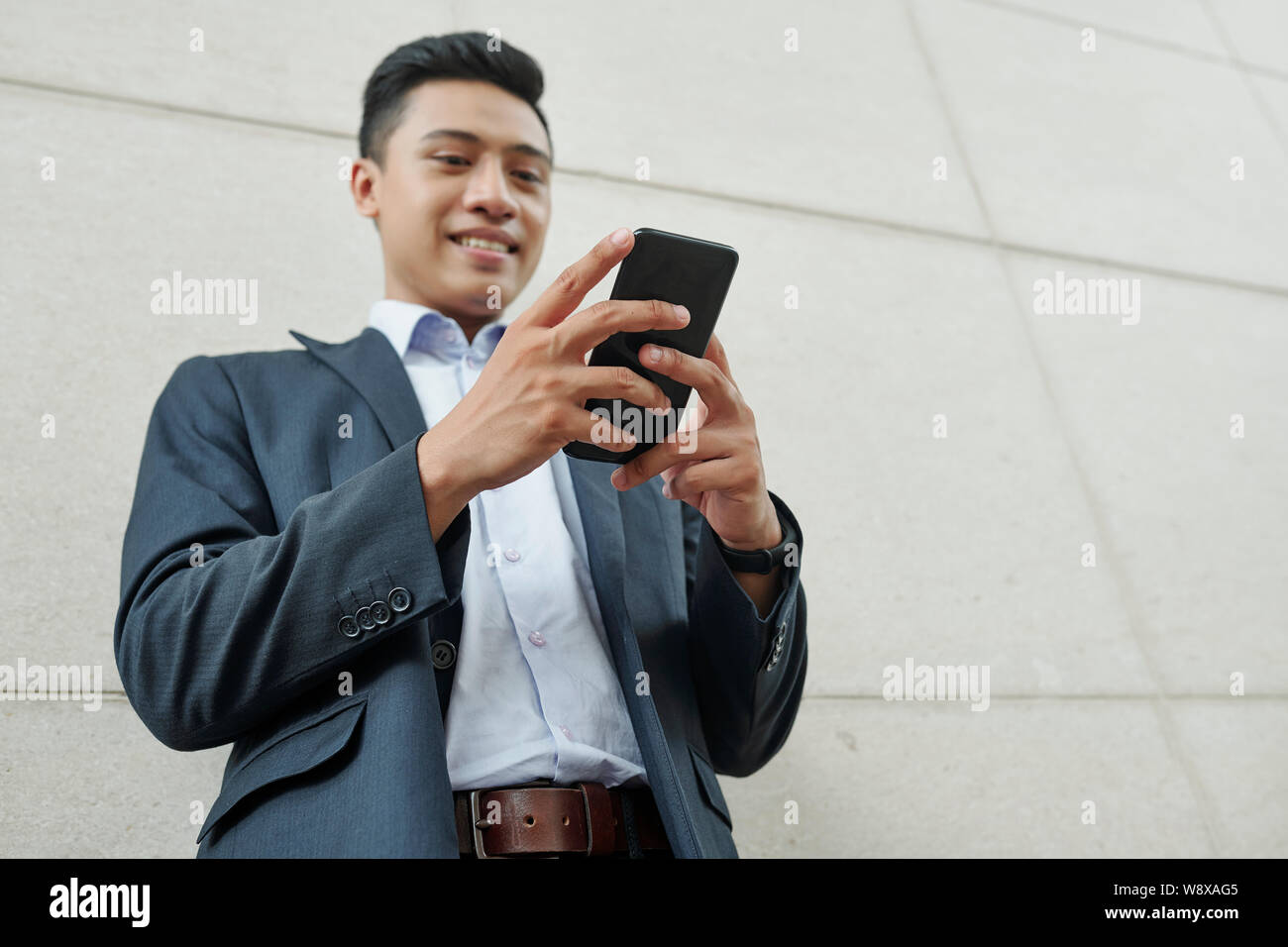Businessman checking text messages Stock Photo - Alamy