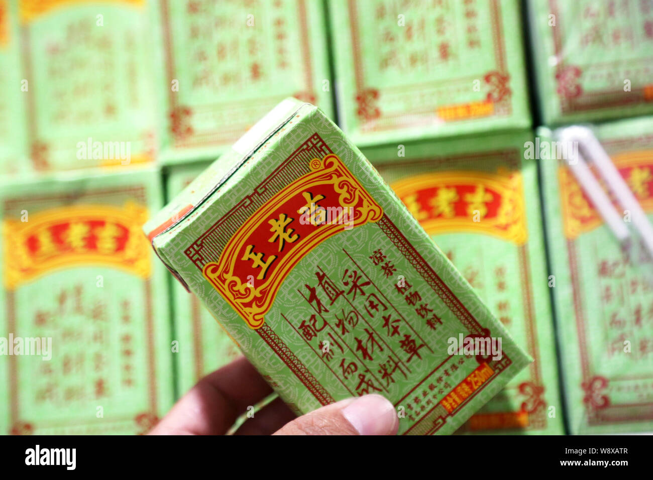 --FILE--A customer buys a carton of Wanglaoji herbal tea at a ...