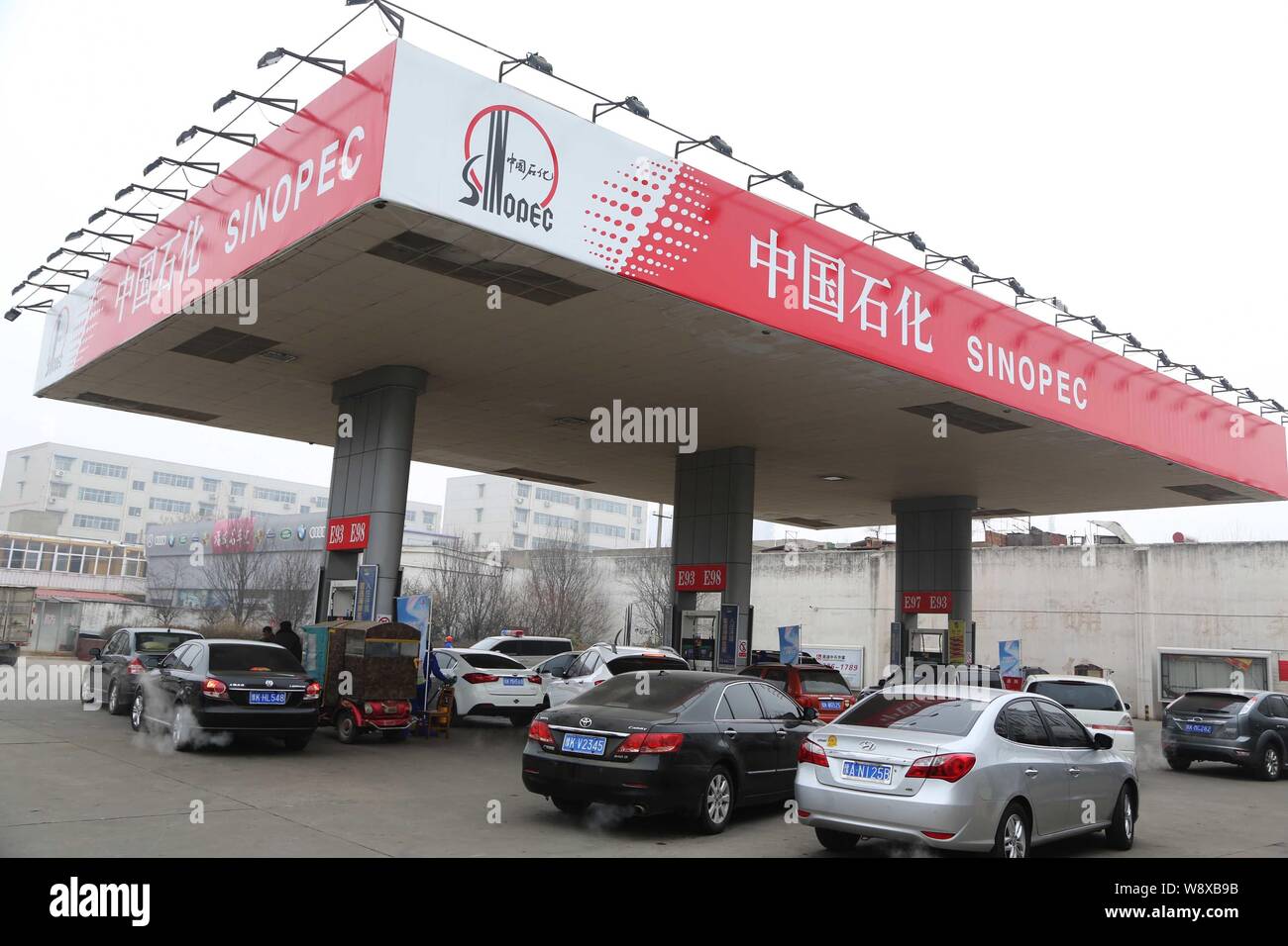 --FILE--Cars to be refueled line up at a gas station of Sinopec in ...