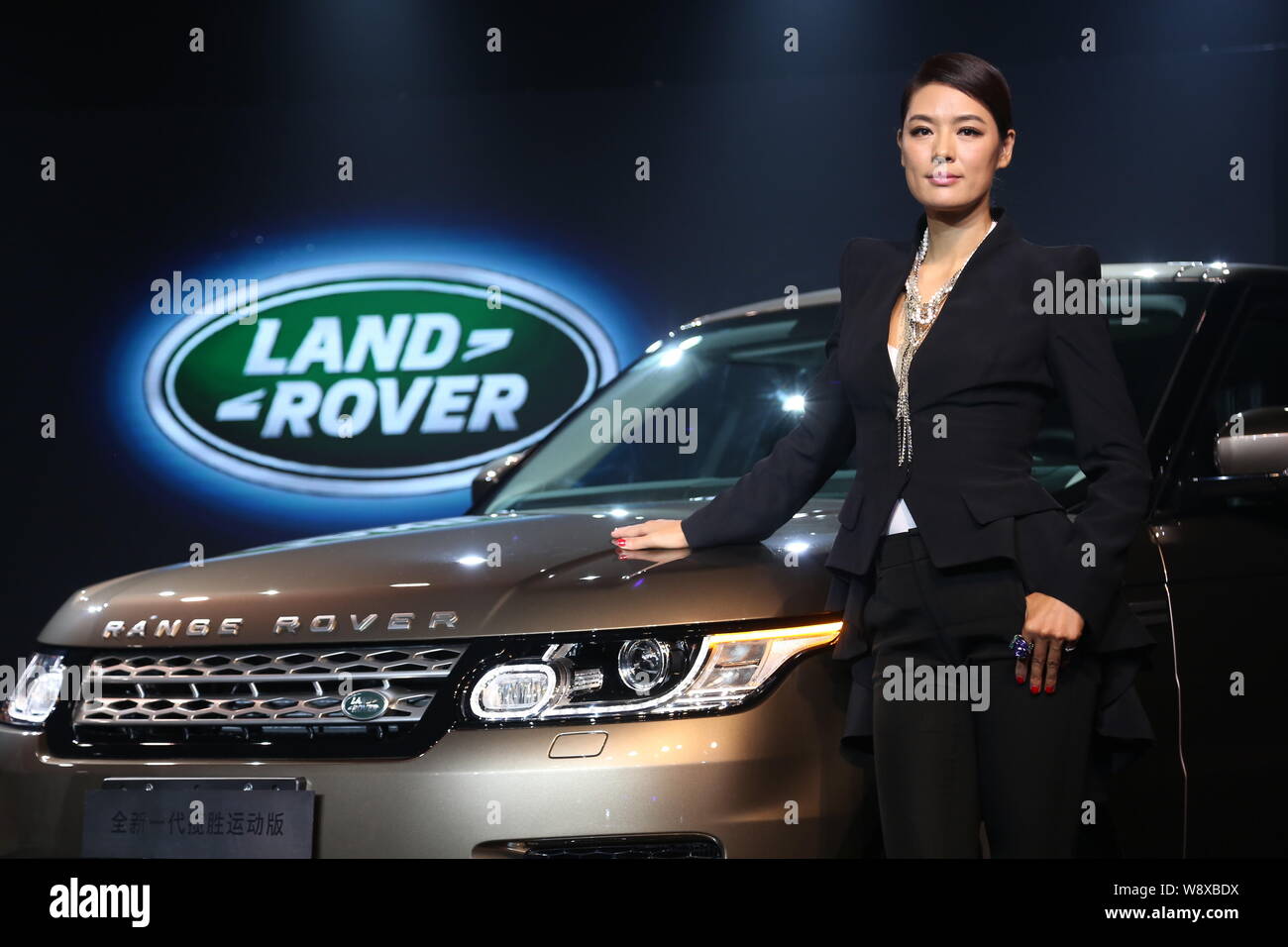 --FILE--Chinese model Mary Ma poses with a Land Rover Range Rover SUV ...