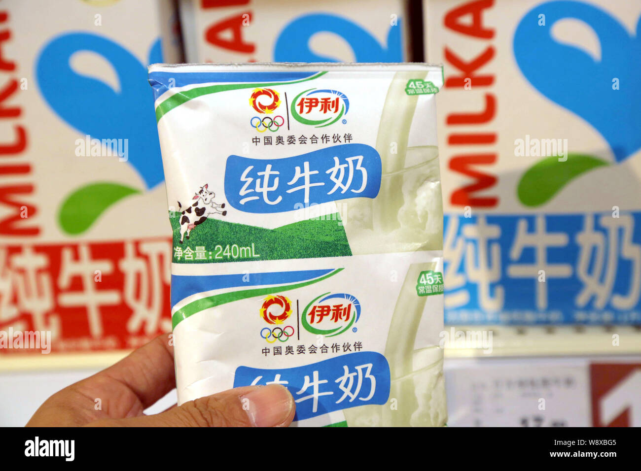 --FILE--A Chinese customer buys Yili pure milk at a supermarket in ...