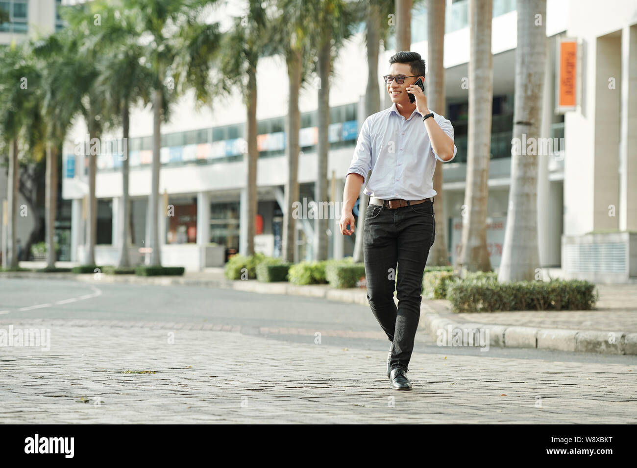 Confident man walking outdoors Stock Photo - Alamy