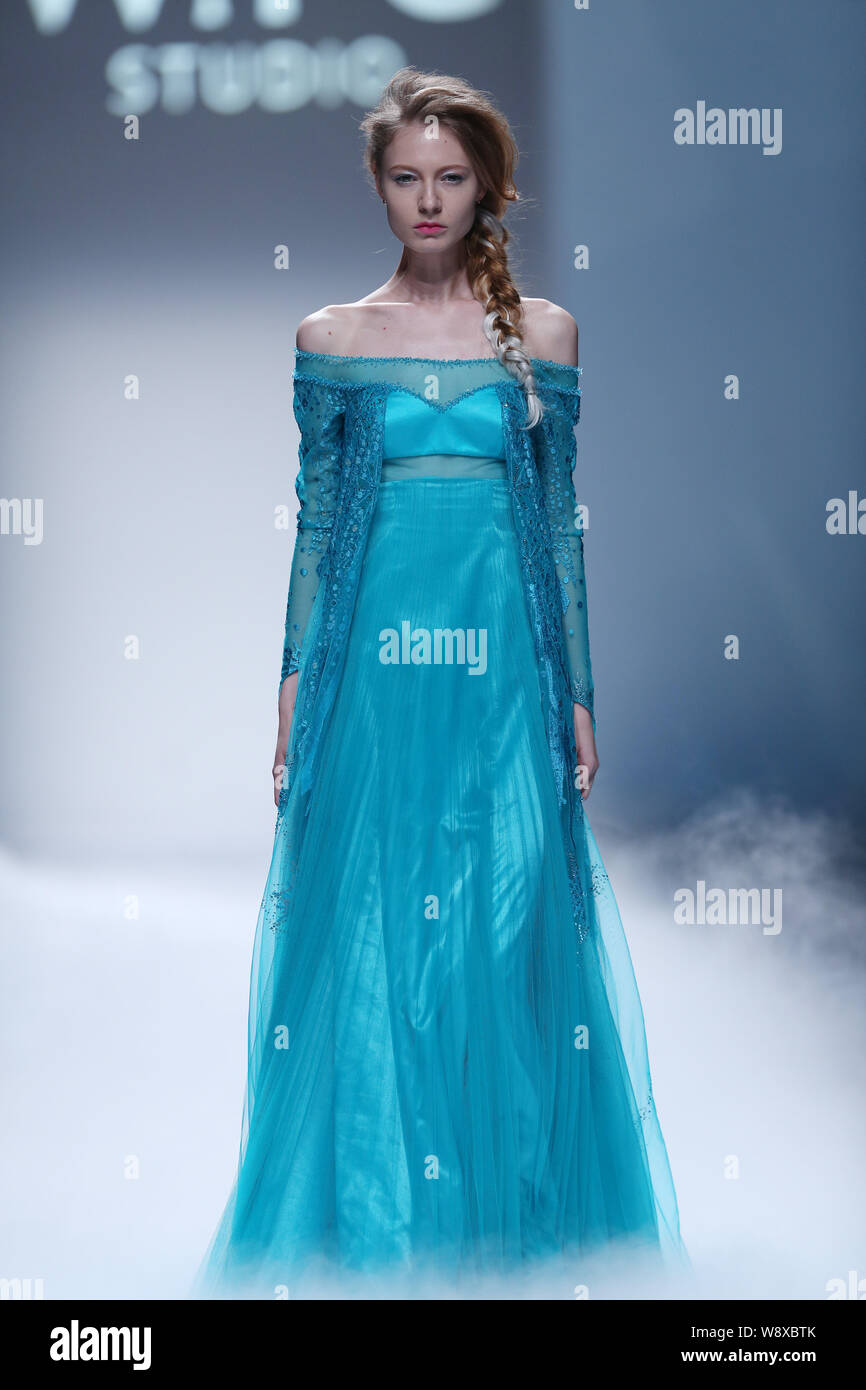 A model displays a new creation at the fashion show of Disney Princess ...