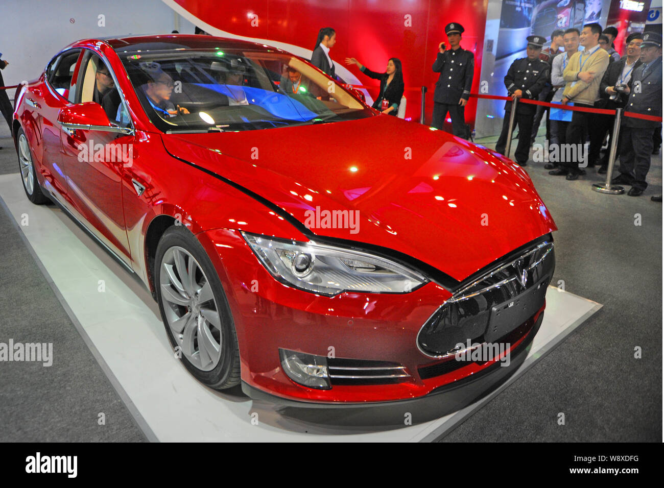--FILE--Visitors try out a Tesla Model S electric car on display during ...