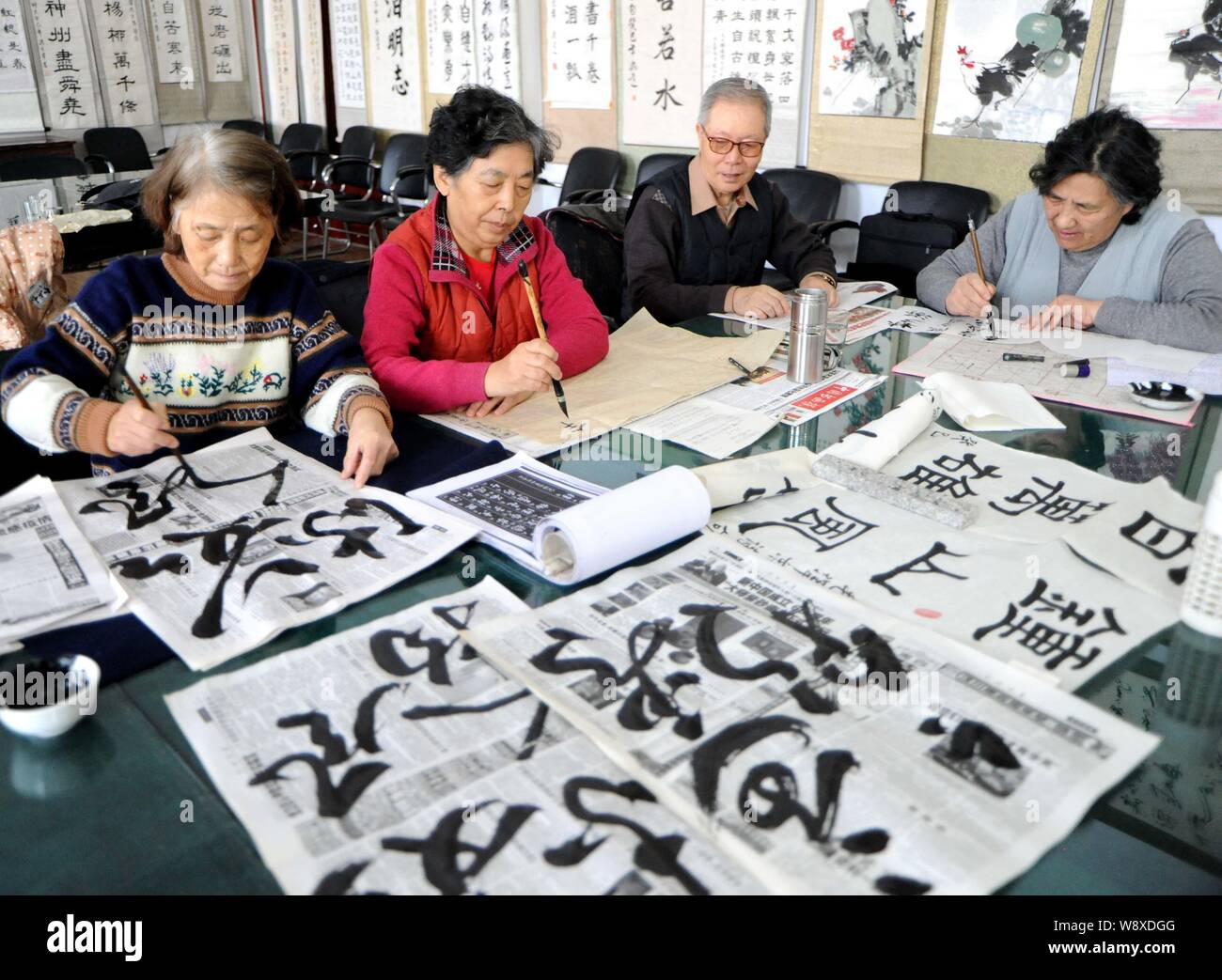 --FILE--Chinese retirees practice writing calligraphy at a retired ...