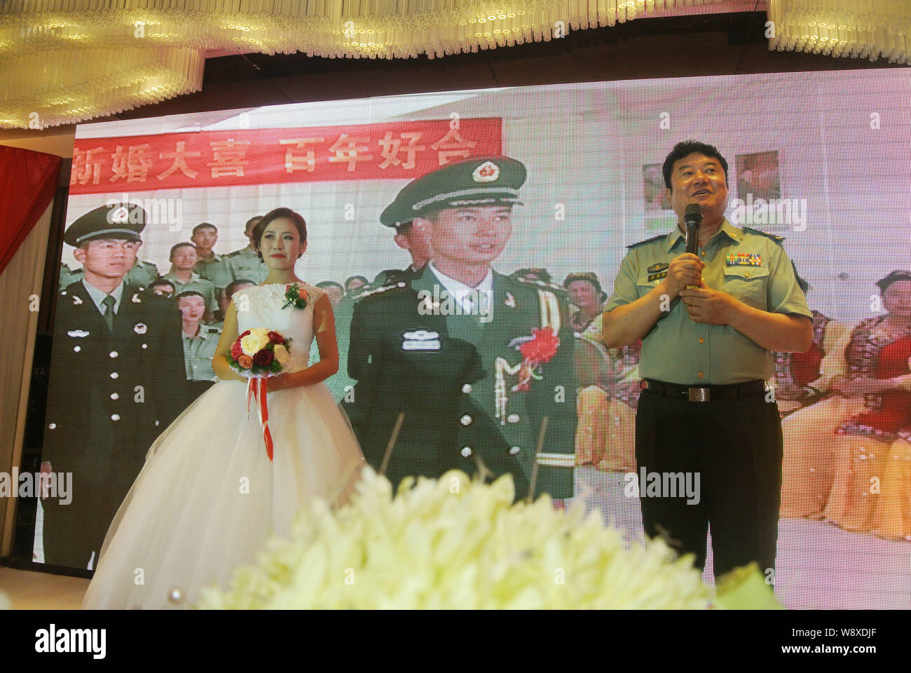Liang Tao, center, the frontier army leader in the video, and his bride ...