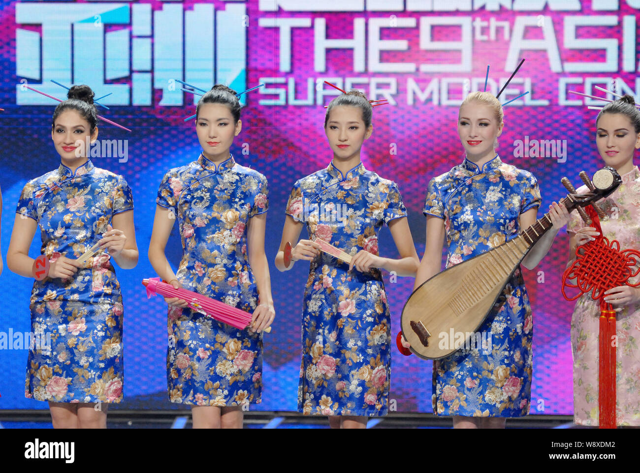 Chinese and foreign models display creations of cheongsam, also known ...