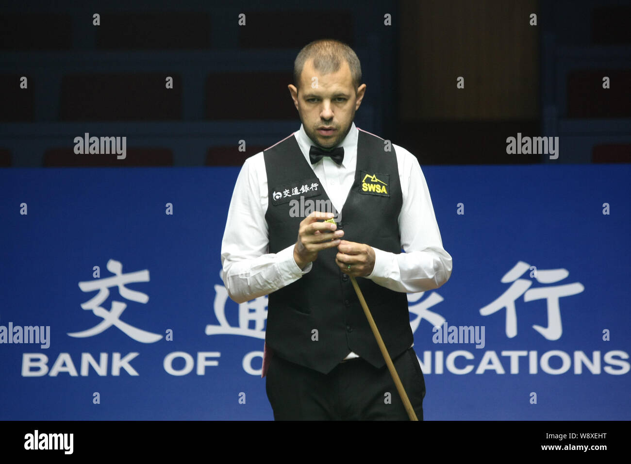 Barry Hawkins of England chalks his cue as he considers a shot against ...