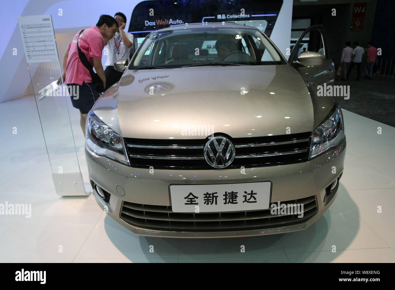 --FILE--Visitors look at a New Jetta of FAW-Volkswagen, a joint venture ...